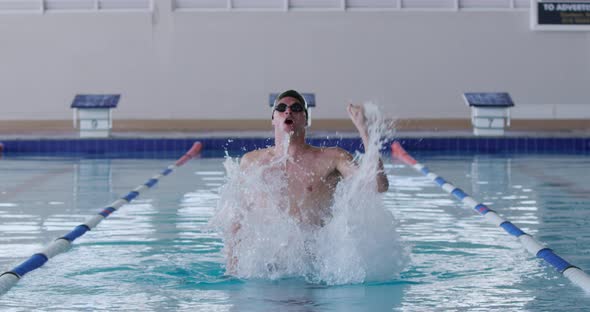 Swimmer coming out of the water and raising arm, Stock Footage | VideoHive