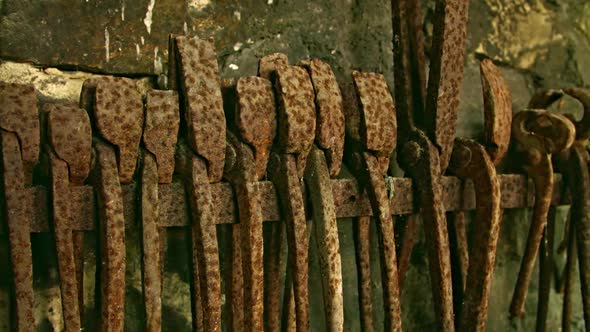 In an Old Forge Rusty Tongs are on an Rack., Stock Footage | VideoHive