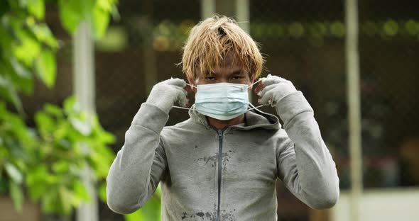 Homeless man wearing face mask and looking at camera., Stock Footage