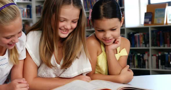 School kids reading book together in library, Stock Footage | VideoHive