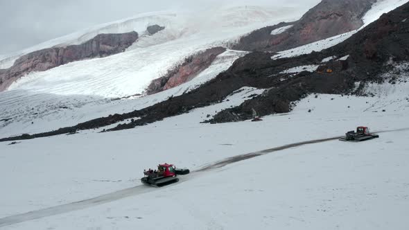 Mechanical Red Snowcat Bus Drives Along Track on White Mountain Slope ...