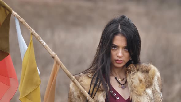 mestizo young woman in ethnic clothes with a stick with rags in the ...
