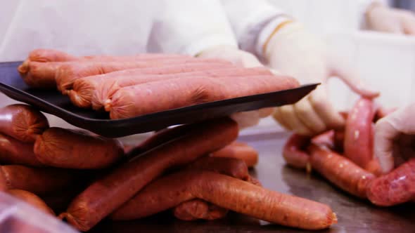 Butchers packing sausages in container, Stock Footage | VideoHive