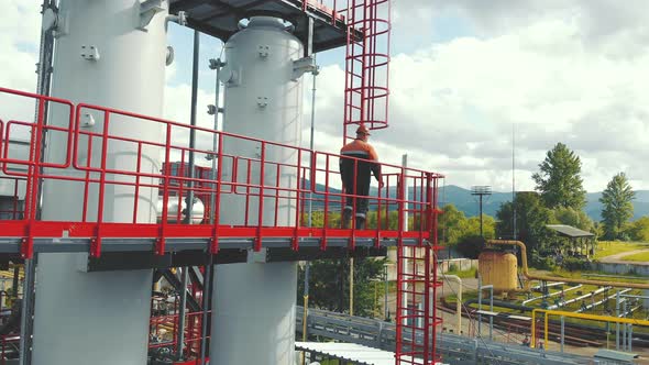 Aerial View Gas Station Operator Climbs To the Top of the Station ...