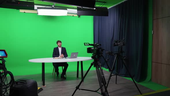 News Anchor at Work Man Reporter Looks Into the Camera and Talks View ...