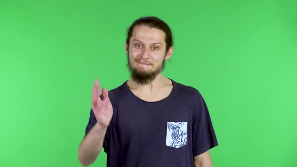 The Man Waves His Hand Smiling Greeting Then Shows a Gesture with His ...