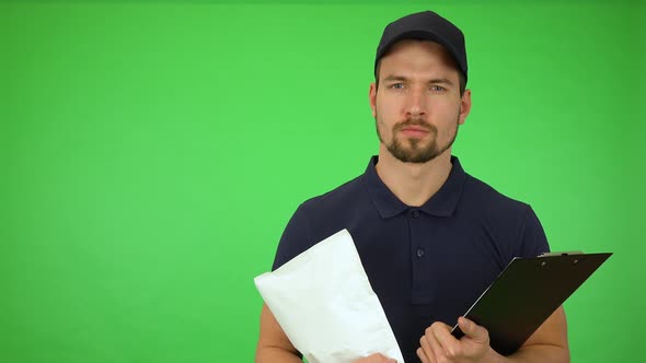 A Young Handsome Mailman Looks Seriously at the Camera - Green Screen ...