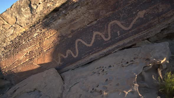 Walking up to boulder with snake petroglyph on it from native american ...