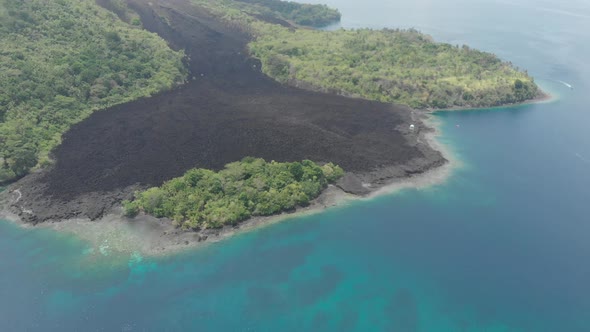 Aerial: flying over Banda Islands active volcano Gunung Api lava flows ...