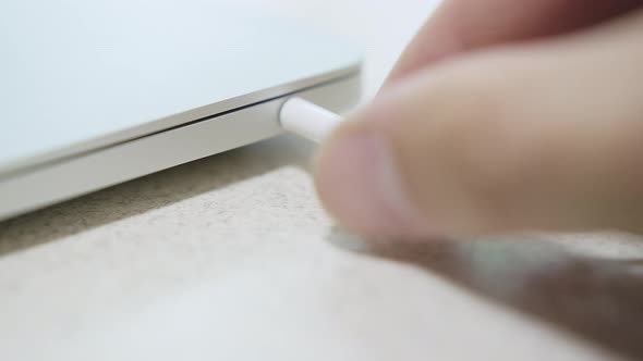 Caucasian Male Hand Unplugging Headphone Jack From a Silver Laptop ...