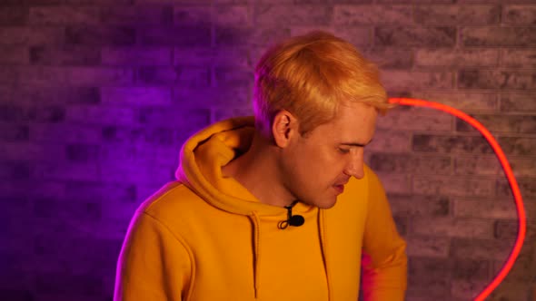 Young Man with Lavalier Microphone Talking on Camera Against ...