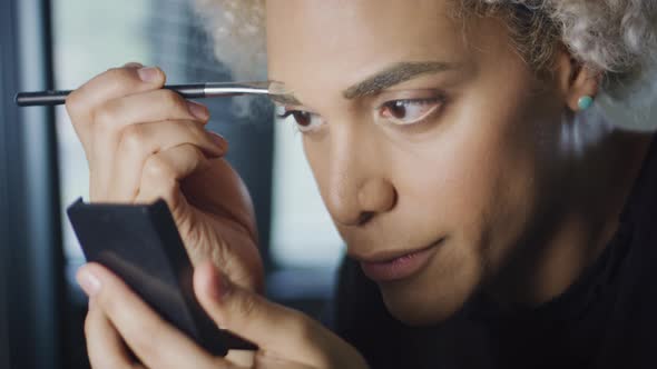 Closeup of Transgender Woman Putting Makeup Around Eyebrows, Stock Footage