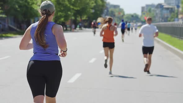 Plus Size Woman Running Marathon and Checking Pulse, Stock Footage