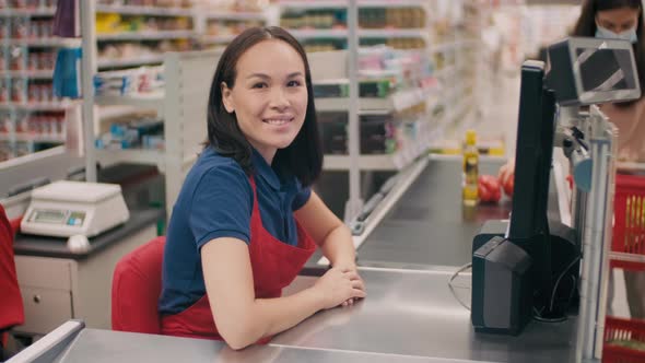 Smiling Female Cashier In Supermarket, Stock Footage | VideoHive