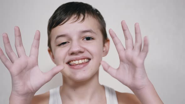 Smiling Boy Waving Arms Showing Gestures of Greeting Goodbye Looking at ...