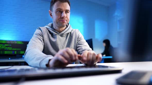 Middle Shot of Nervous Programmer Typing on Computer Keyboard in Blue ...