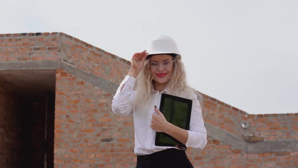 Female Architect in Business Attire Stands in a Newly Built House with ...