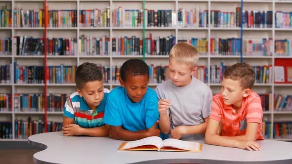 School kids reading book together in library, Stock Footage | VideoHive