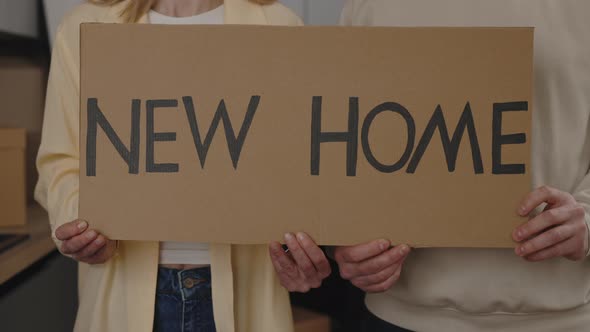 Close View of the Couple Hands Holding the Paper Banner on the Hew Home ...