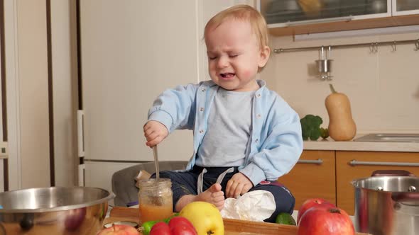 Little Crying Baby Boy Trying Eating Porridge with Spoon on Kitchen ...
