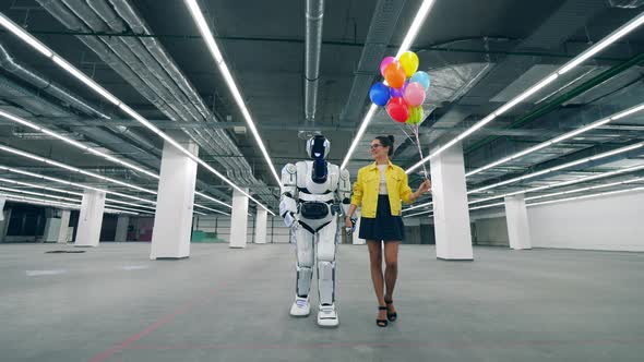 A Lady with Balloons Is Walking with a Cyborg Along the Hall, Stock Footage