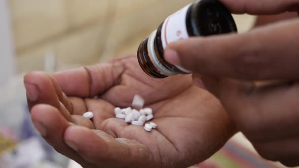 Micro shot of taking out tablets over another hand, close view of white ...