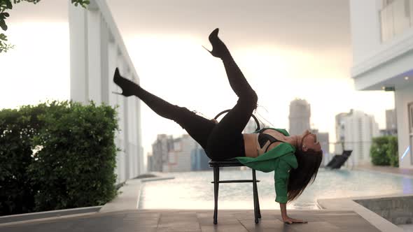 Sensuous Dancer Leaning Back On Chair And Kicking Legs In High Heels ...