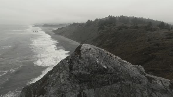 Aerial footage of Sharp Point rock in front of the ocean at Dry Lagoon ...