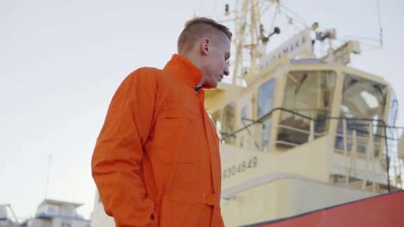 Harbor Master in Orange Uniform Standing in Front of a Large Ship in ...