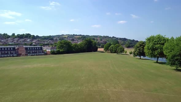 Aerial, drone launching from field revealing Exeter cityscape in UK on ...