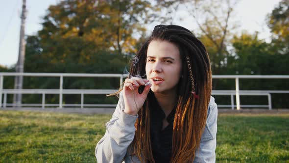 Portrait of Young Pretty Woman with Dreadlocks Smoking Marijuana Joint ...