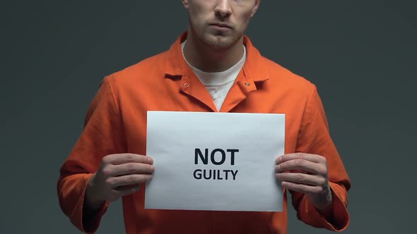 Not Guilty Phrase on Cardboard in Hands of Caucasian Male Prisoner ...