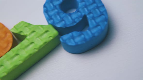 Motion Over Colorful Foam Rubber Numbers on White Surface, Stock Footage