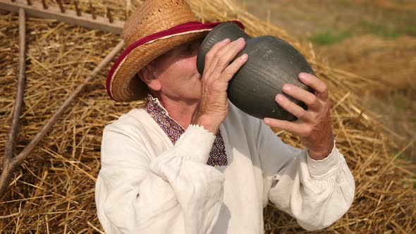 Thirsty Old Man Grandpa Drinks Water From Jug, Stock Footage | VideoHive