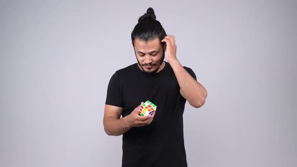 Confused Indian tries to solve rubik's cube, Stock Footage | VideoHive