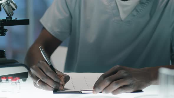 Black Lab Worker Taking Notes and Using Microscope, Stock Footage ...