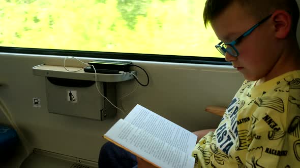 Little Boy in Eyeglasses Reading Book in Train, Stock Footage | VideoHive