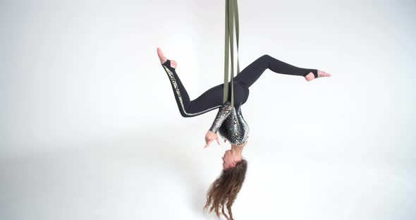 Young Woman is Hanging Upside Down Doing a Split on Strings Aerial ...