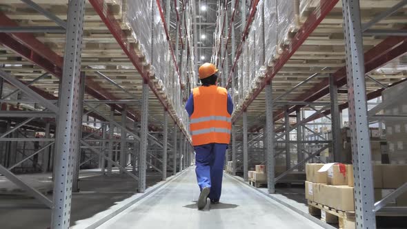 Auditor Counts Merchandise in Warehouse. He Walks Between Rows of ...