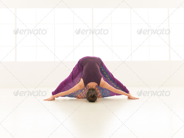 demonstration of difficult stretching yoga pose Stock Photo by shotsstudio