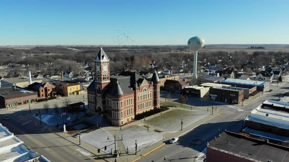 Drone video circling around a historic brick Court house building in a ...