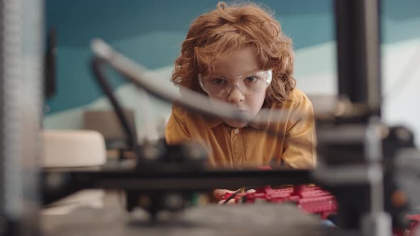 Red-haired Boy Watching Machine Working in Classroom, Stock Footage