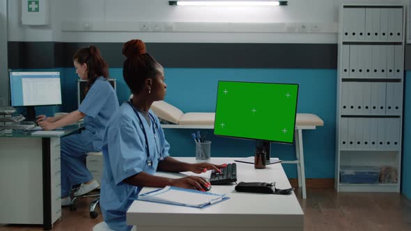 Medical Assistant Using Computer with Horizontal Green Screen, Stock ...