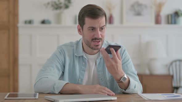 Upset Young Man Talking Angrily on Smartphone in Office, Stock Footage