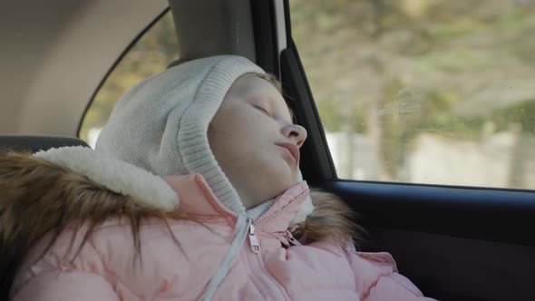 The Child Sleeps While Driving in the Back Seat of a Car, Stock Footage