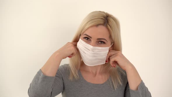 Young Woman is Taking Off Her Face Mask Happy with Coronavirus Pandemic ...