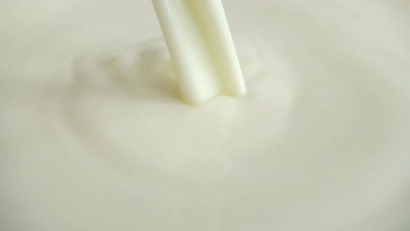 A pouring stream of milk into the milky surface. Slow motion., Stock ...