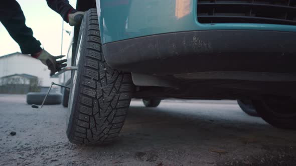 Man taking off a tyre from a car. Tyre changing process, Stock Footage