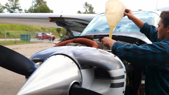 Engineer filling oil in aircraft engine 4k, Stock Footage | VideoHive
