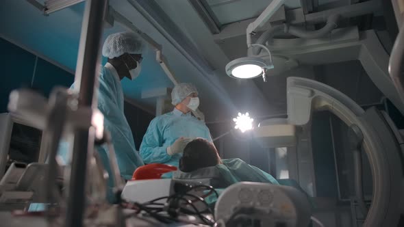 Diverse Doctors Examining Screen During Surgery, Stock Footage | VideoHive